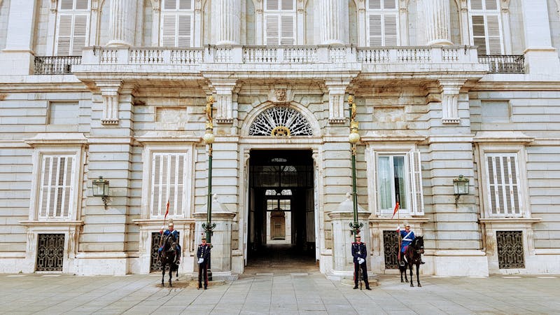 Guards and cavalry standing at the entrance of the Royal Palace of Madrid