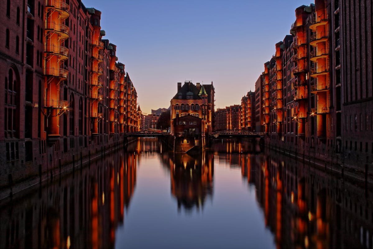 The iconic Wasserschloss building in Hamburg Speicherstadt district at twilight with canals