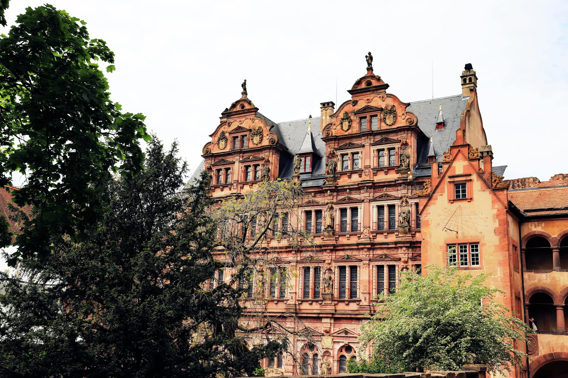 Renaissance facade of Heidelberg Castle surrounded by trees