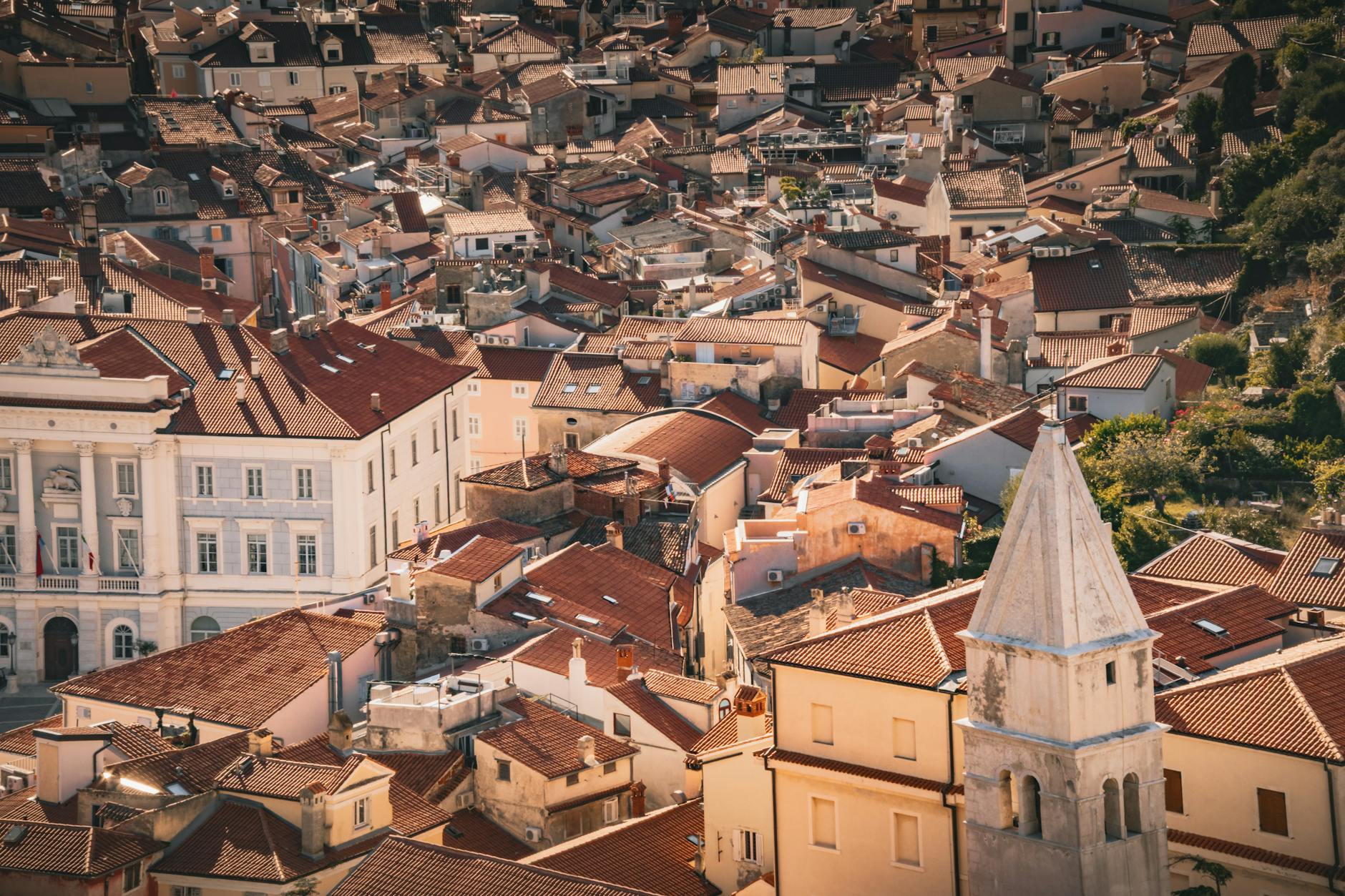 Aerial view of a historic European town with red-tiled roofs