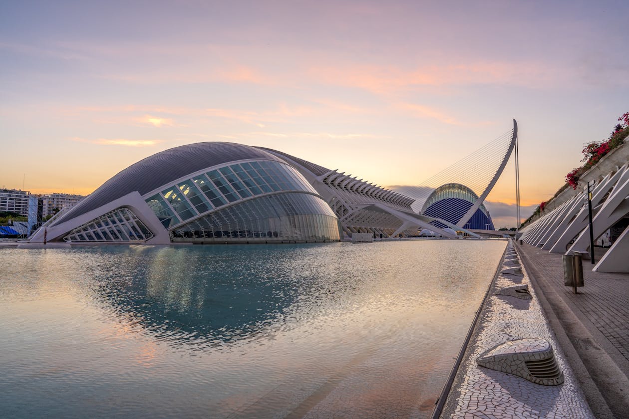 The Hemisferic and City of Arts and Sciences buildings at dusk with reflections in Valencia