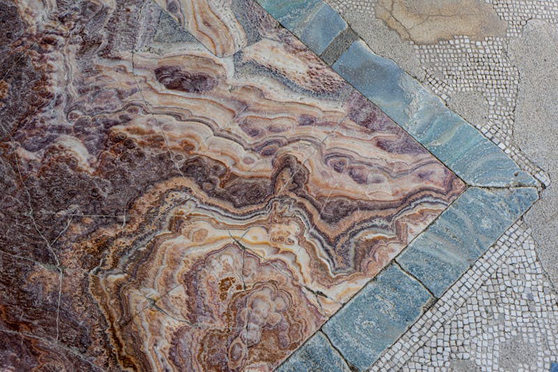 Close-up of intricate marble and mosaic floor patterns preserved at the Herculaneum archaeological site