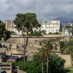 Panoramic view of the excavated ruins of Herculaneum with the modern town of Ercolano above and Mount Vesuvius in the background