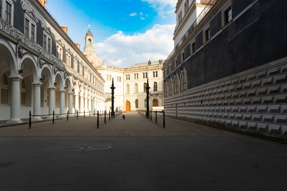 A historic courtyard with stone arches and tower in Dresden old town