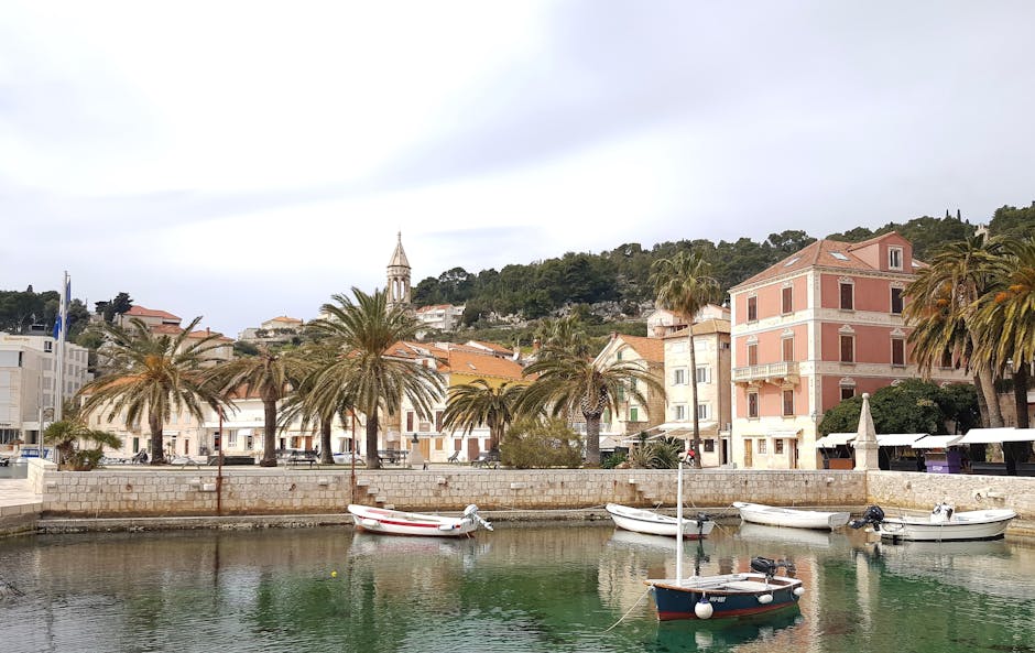 Hvar harbor with sailing boats and historic stone buildings