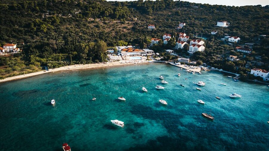 Aerial view of a Dalmatian island with boats and clear water