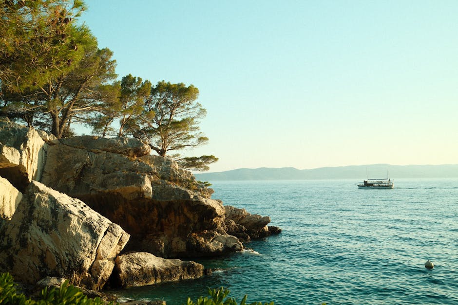 Serene view of the Adriatic with rocky coastline and a lone boat