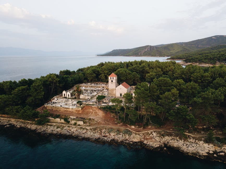 Aerial view of a historic stone church above the Croatian coast