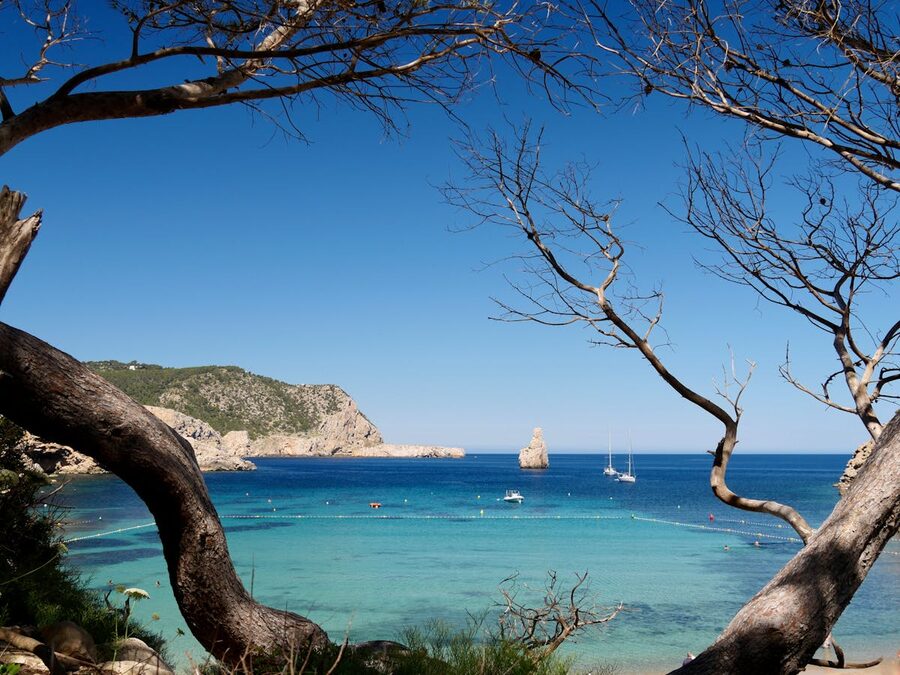 Turquoise water and unique rock formations along Ibiza coastline