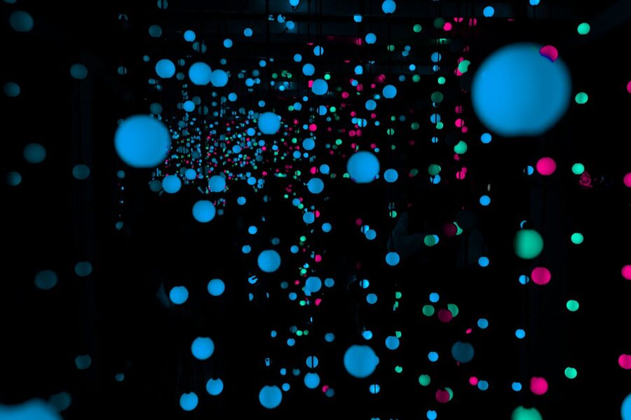 Glowing LED light spheres creating a surreal immersive atmosphere in a dark room