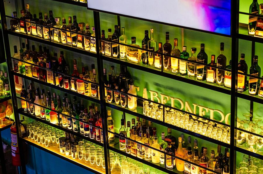 Illuminated bar shelves with various liquor bottles
