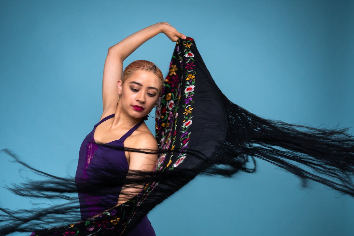 Close-up of a flamenco dancer performing with castanets and traditional dress