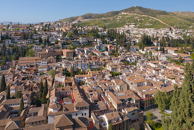 Wide view of Granada city rooftops and Sierra Nevada mountains seen from the Alhambra