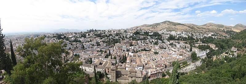Wide panoramic view of the historic Albaicin quarter in Granada with terracotta rooftops