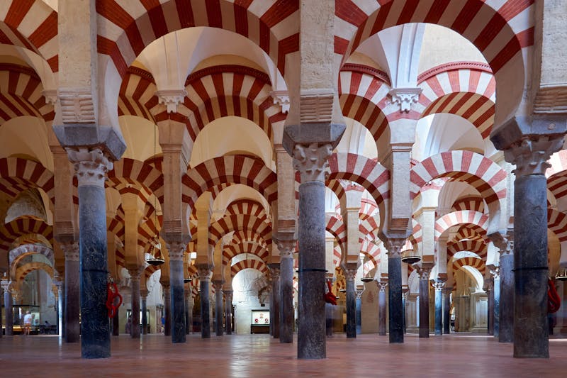 Ornate arches and Islamic geometric patterns inside the Mosque-Cathedral of Cordoba