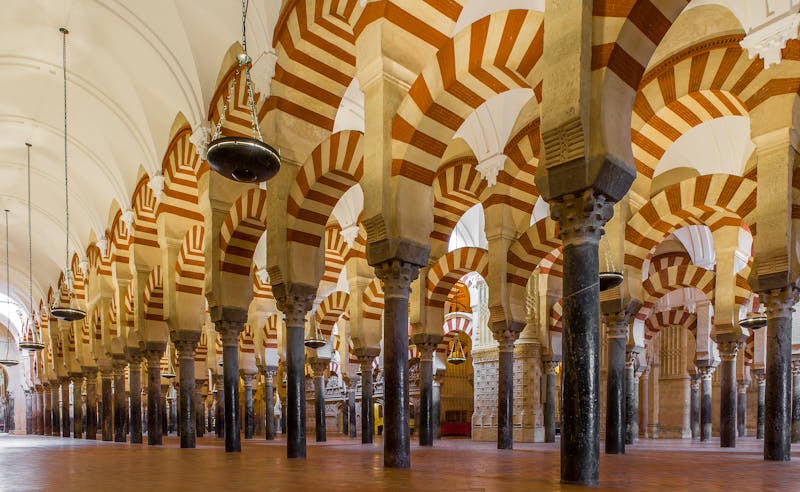Arches within the historic Mosque-Cathedral of Cordoba showcasing Islamic architecture