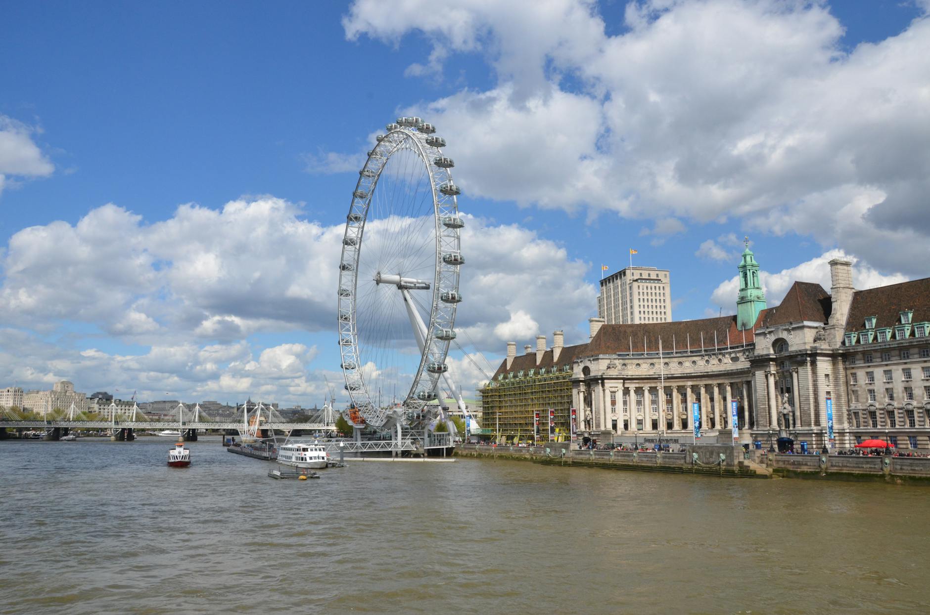 The London Eye beside the Thames on a clear day