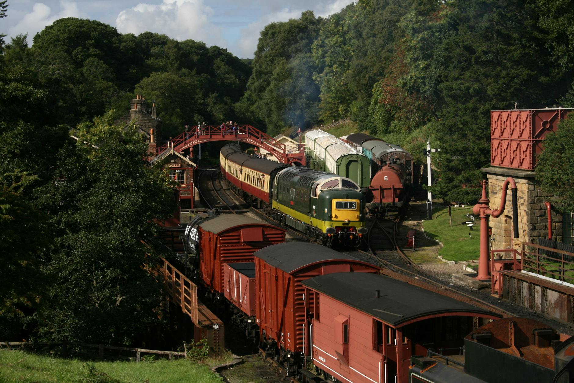 Aerial view of steam trains on North York Moors Railway in green English countryside