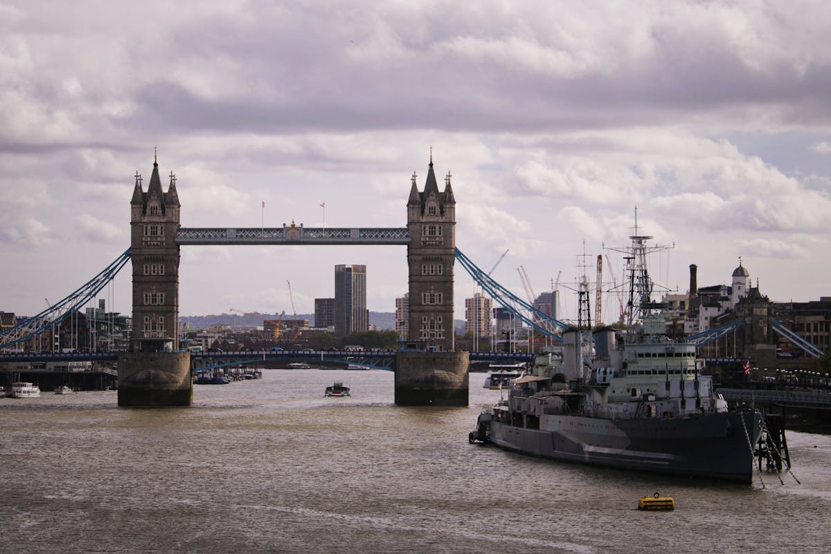 Tower Bridge over the River Thames in London with cloudy skies