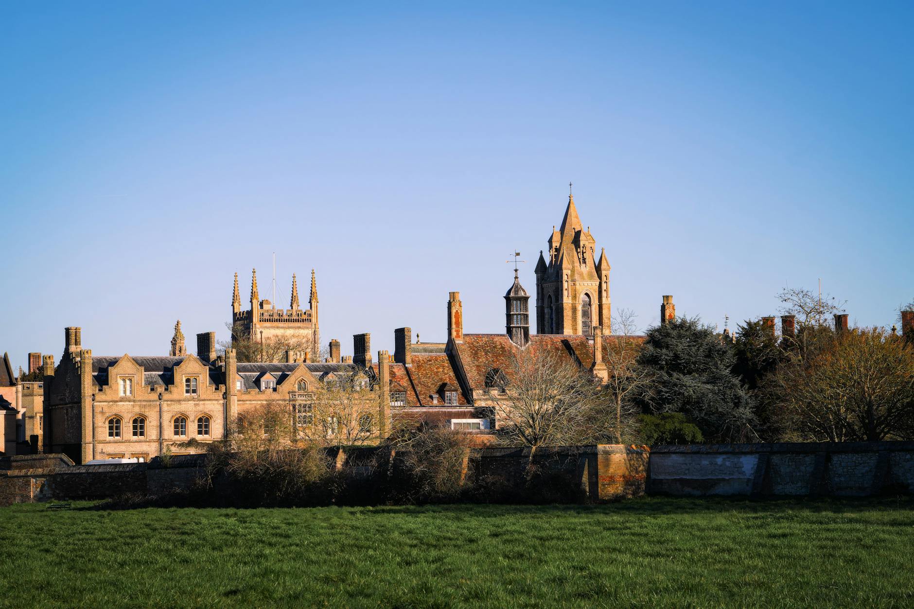 Historic university buildings in Oxford with clear blue sky