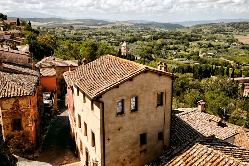 Terracotta rooftops of Montepulciano with lush Tuscan countryside stretching to the horizon