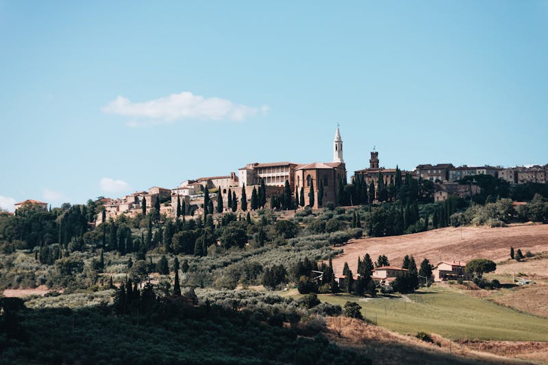 Panoramic view of Pienza hilltop town with Val d Orcia rolling hills and fields in the background