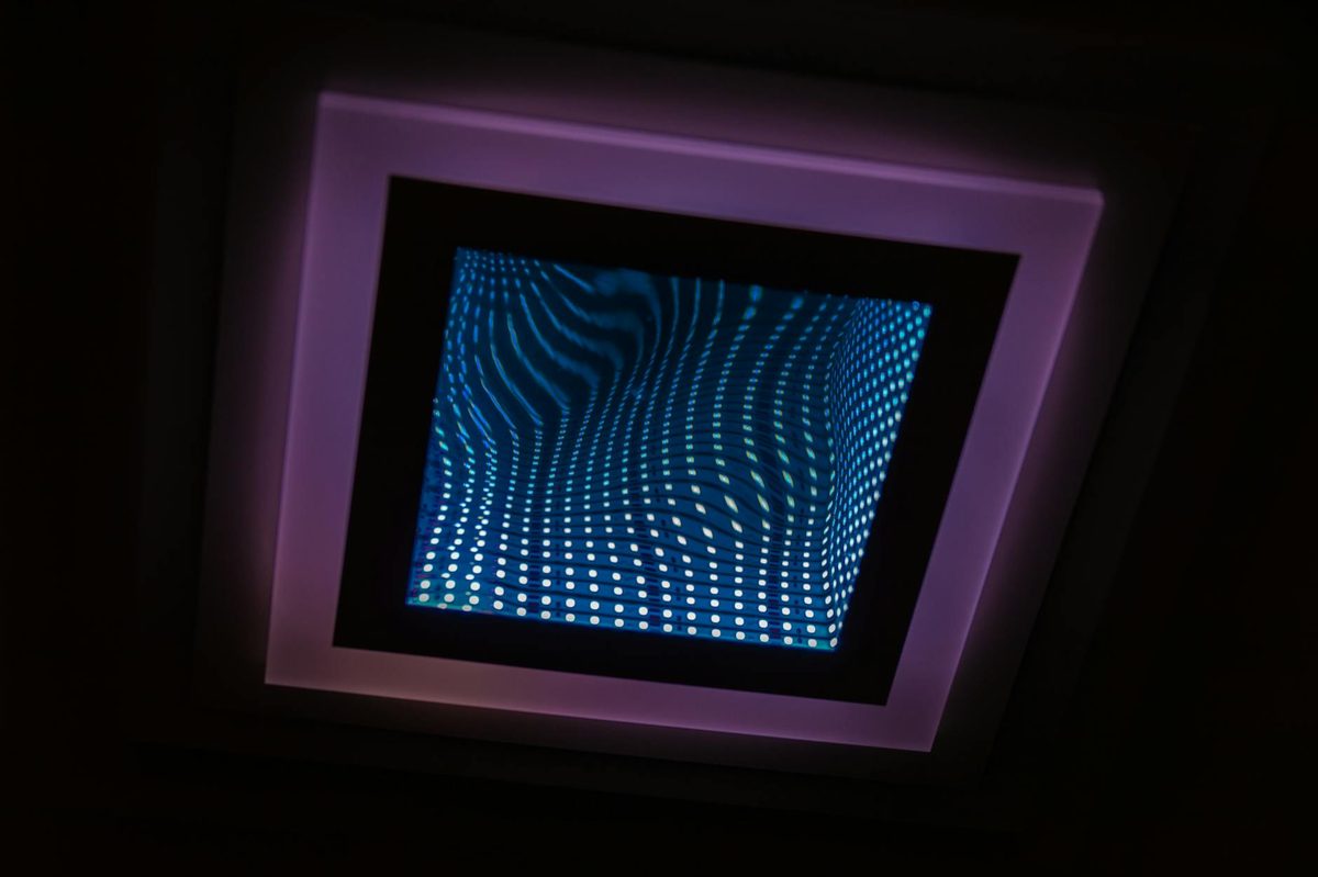 An illuminated infinity mirror creating a depth illusion