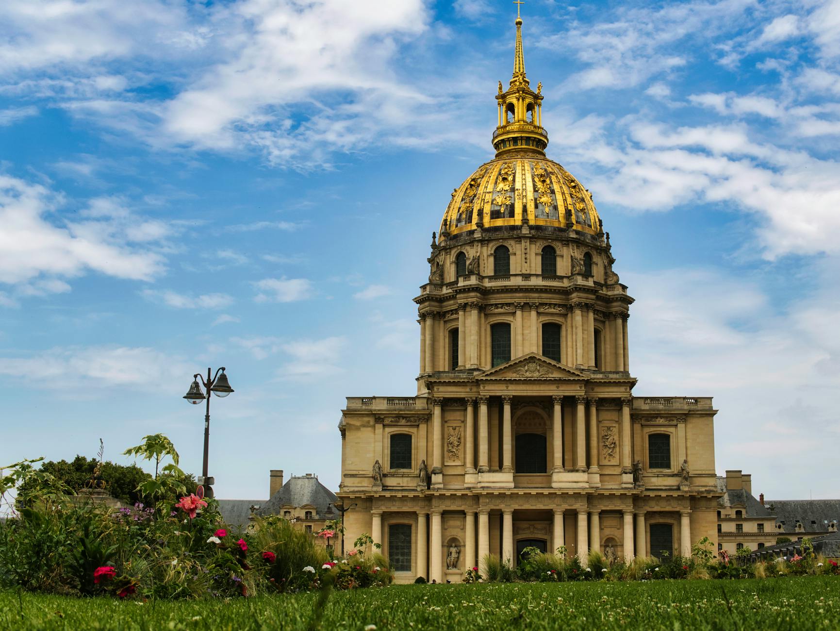 The golden dome of Les Invalides rising above Paris rooftops under a clear blue sky
