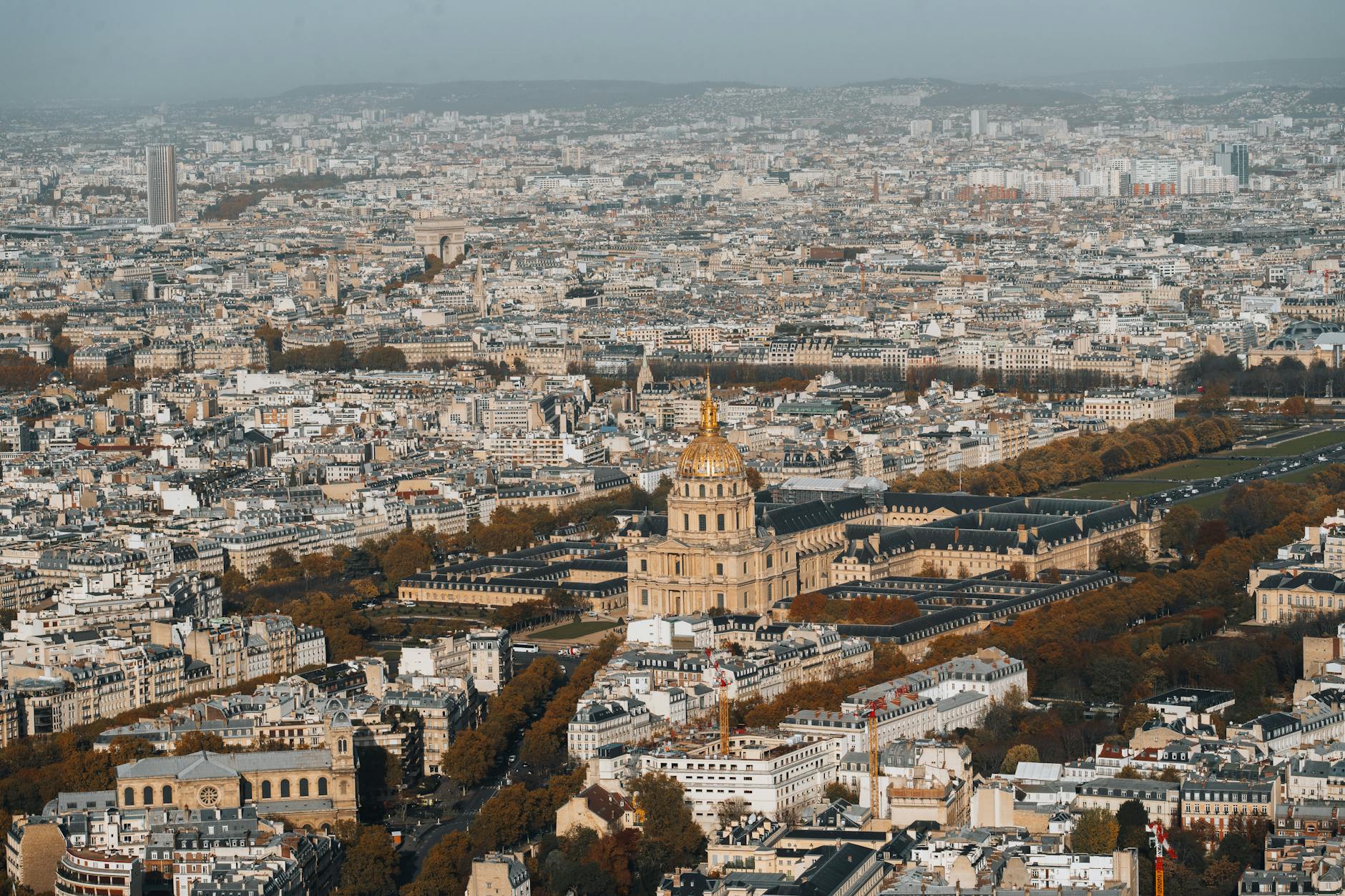 Aerial view of Les Invalides complex showing the golden dome and surrounding Paris cityscape