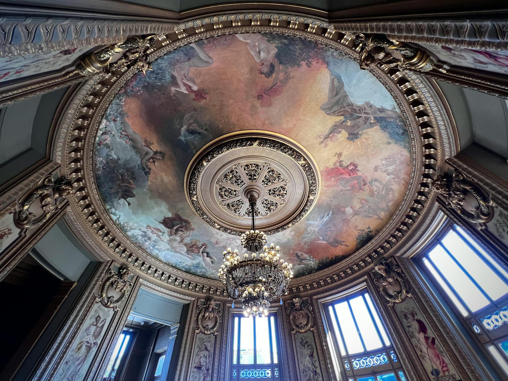 Ornate baroque painted ceiling inside a Paris dome with rich detail and gold accents