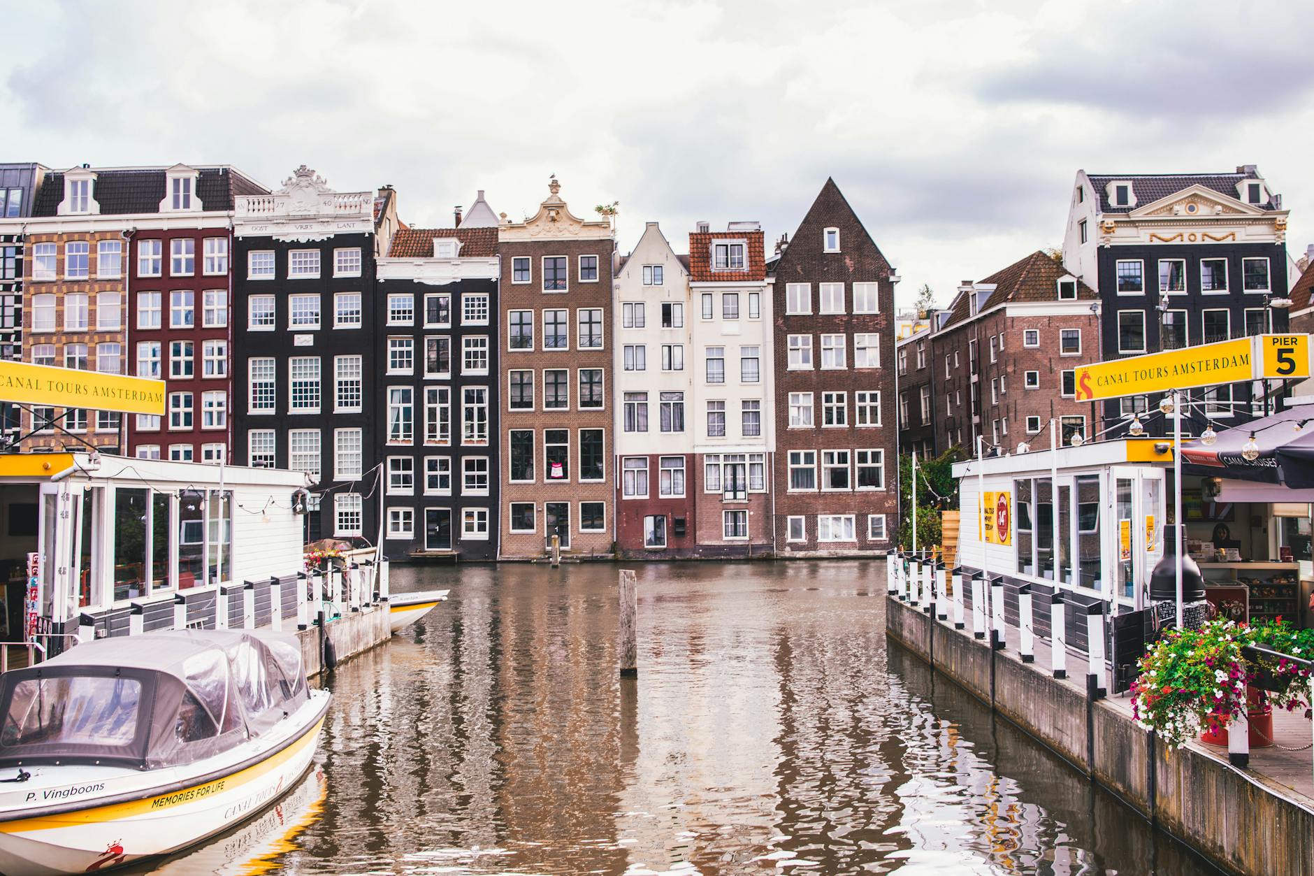 Amsterdam canal with traditional houses and their reflections in the water
