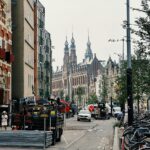 Lively Amsterdam street with historic canal houses and busy pedestrians