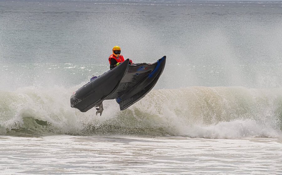 Jet ski rider jumping over ocean waves