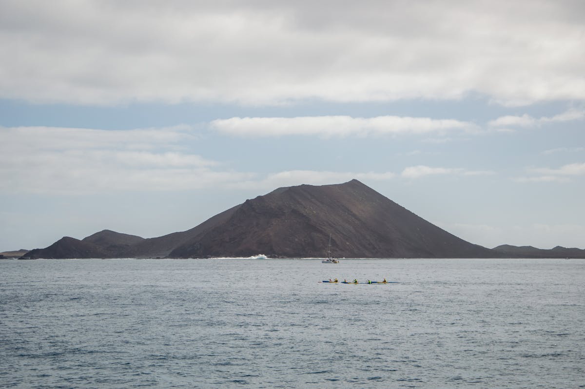 Kayakers paddling near a volcanic island in Corralejo Spain