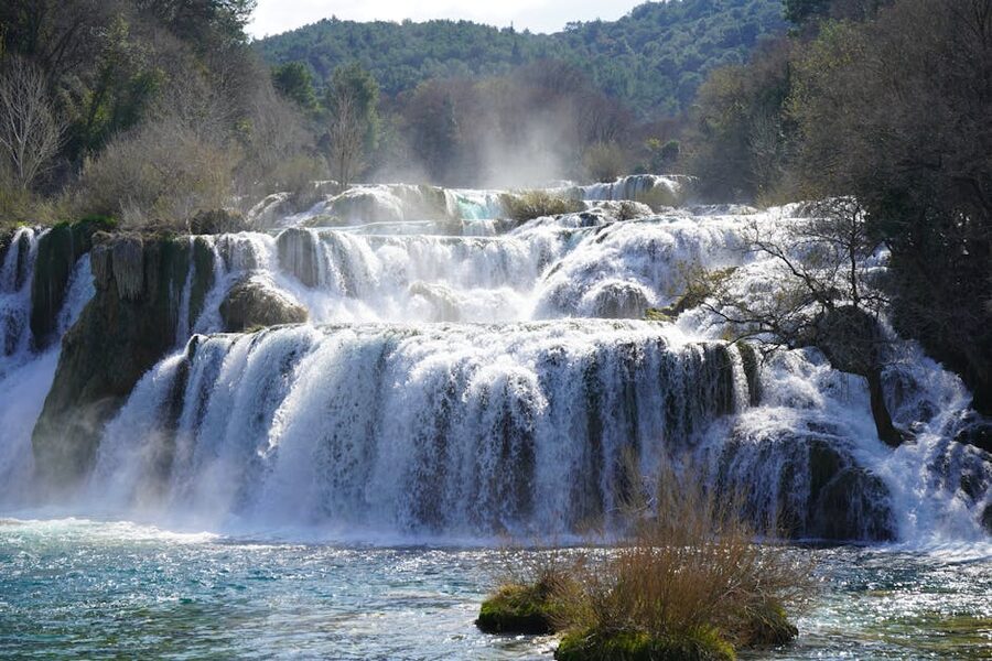 Majestic waterfall cascading in a lush forest landscape