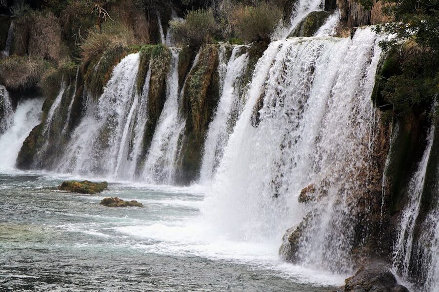 Waterfalls cascading amidst lush greenery in Krka