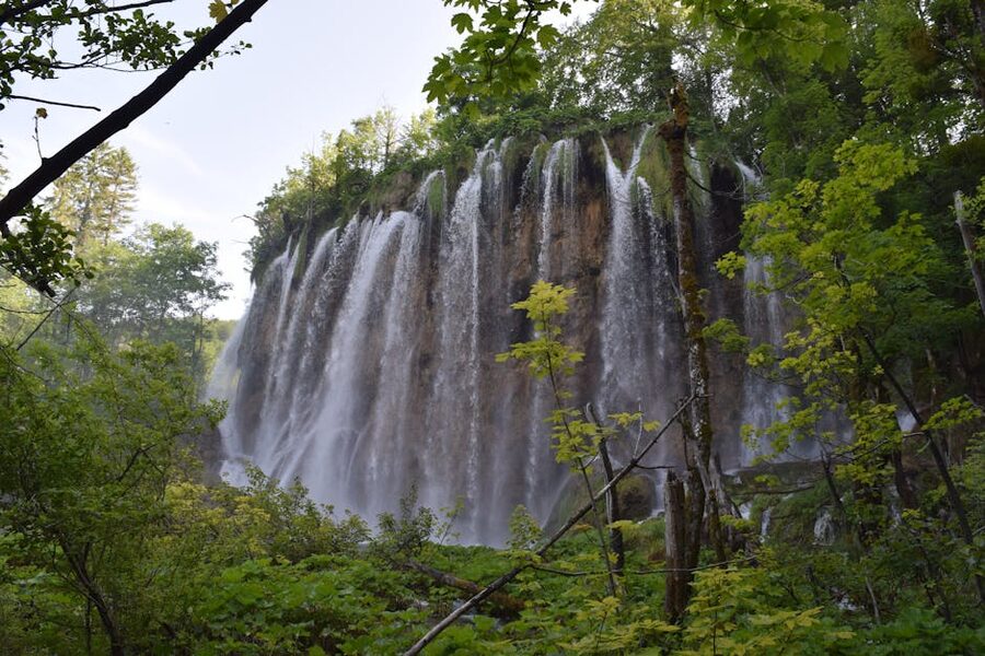 Waterfall cascading through lush forest in Krka