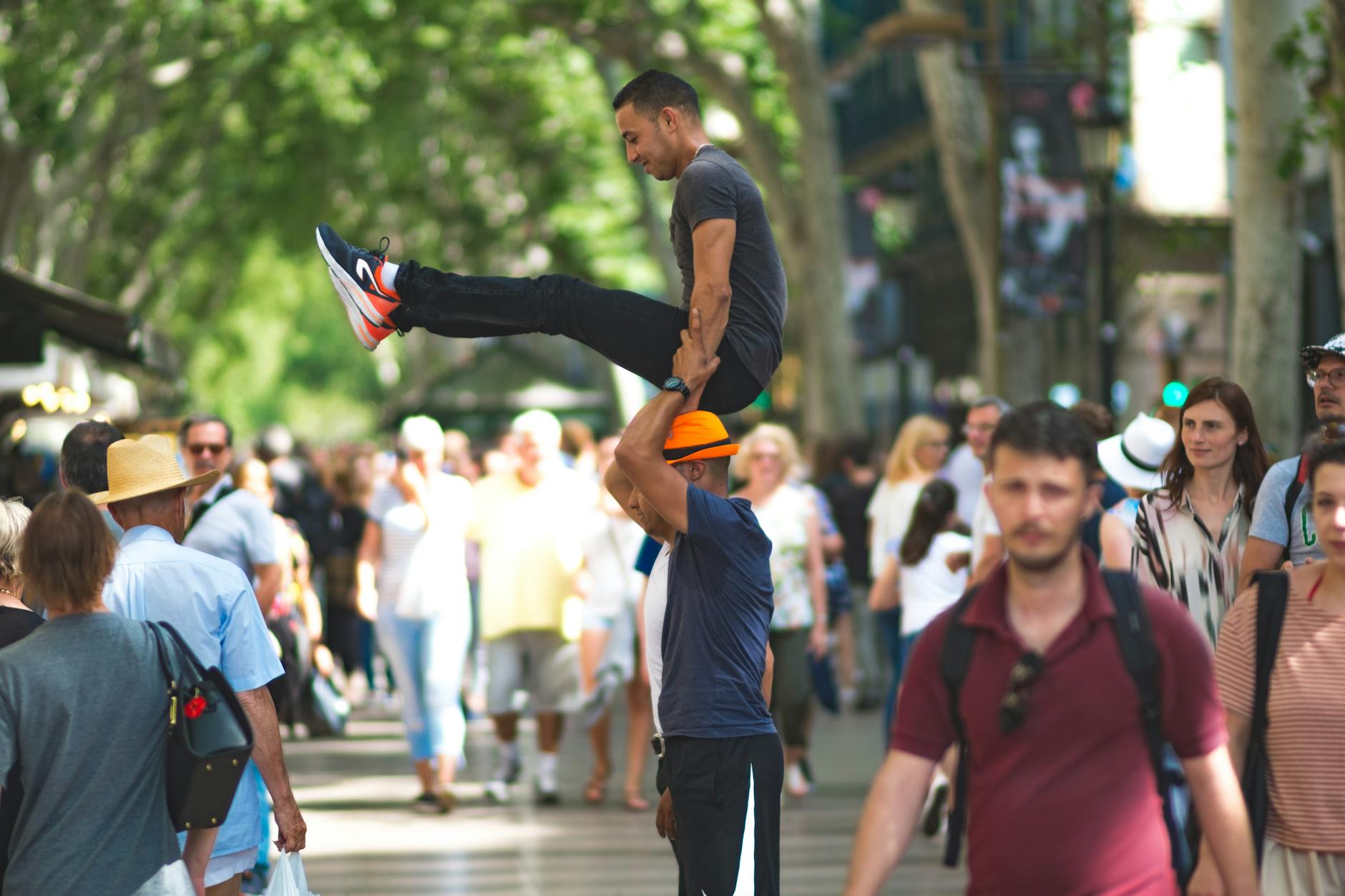Street acrobats performing for a crowd on a Barcelona boulevard