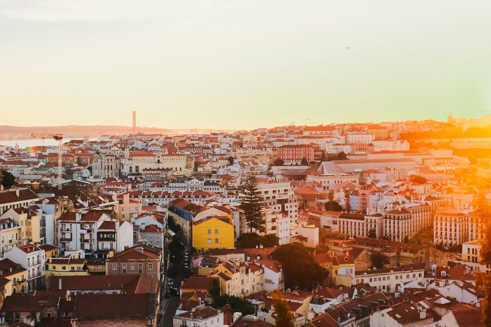 Lisbon rooftops glowing at sunset with historic buildings