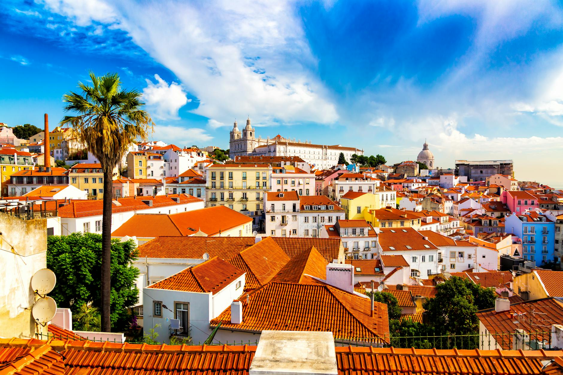 Narrow alleyway in Alfama, Lisbon, with historic buildings and hanging laundry