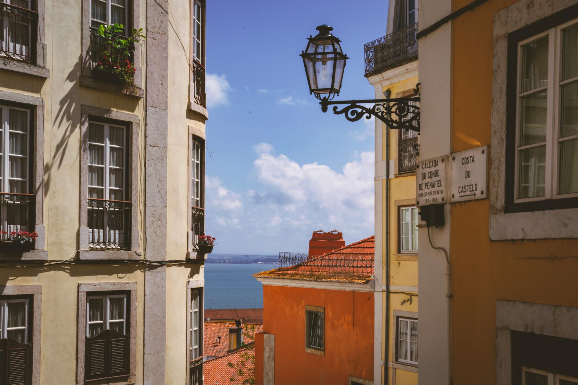 View of Lisbon Alfama neighborhood with colorful buildings cascading down the hillside