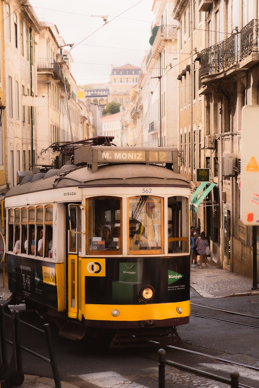 Vintage Lisbon tram on a hillside street with traditional Portuguese buildings