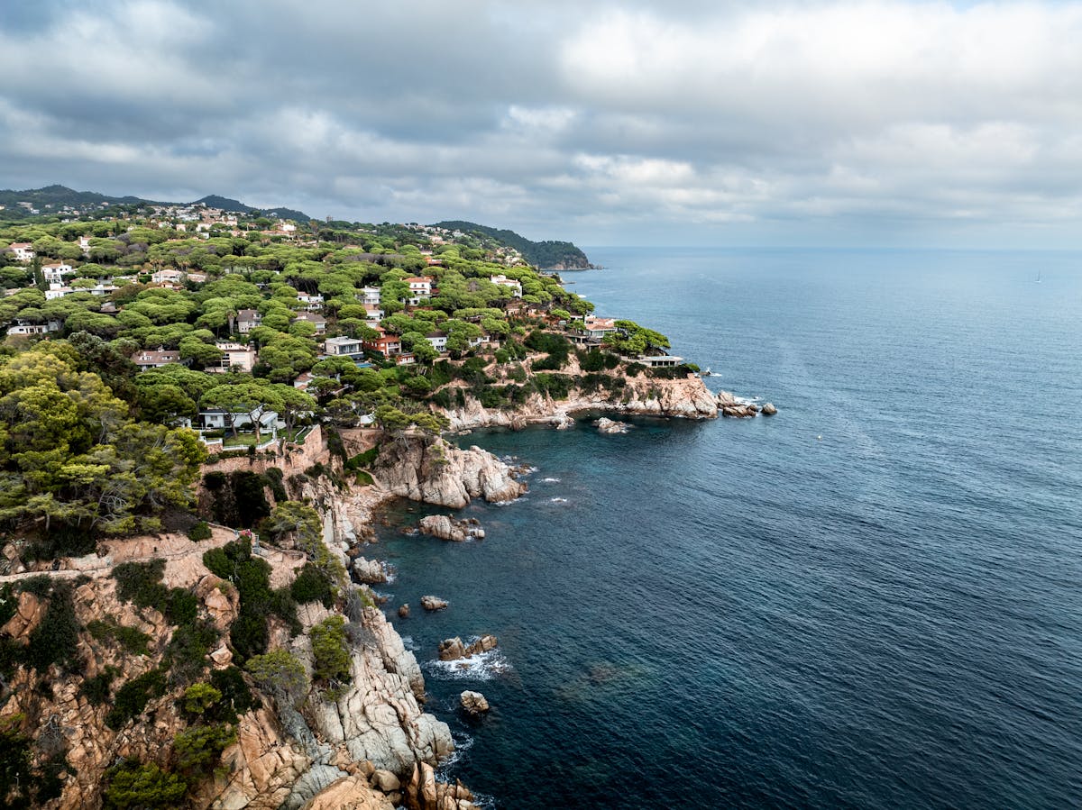 Aerial view of rocky coastline and turquoise waters along Lloret de Mar on the Costa Brava