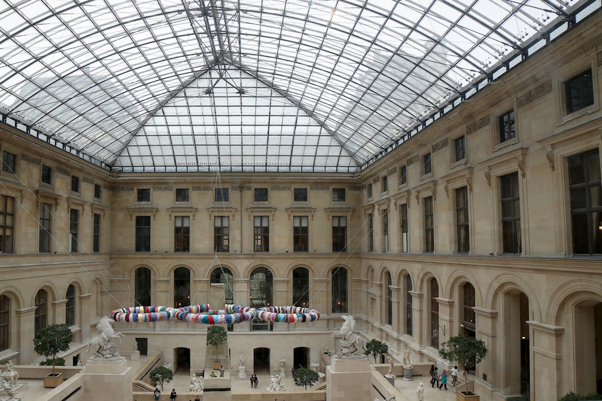 The Louvre Museum glass-roofed courtyard showing classic architecture