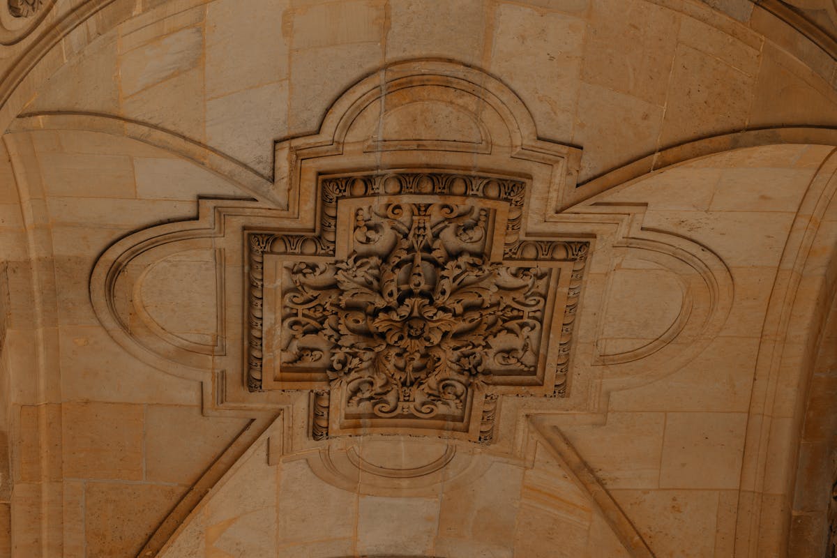 Detailed stone ceiling decoration inside the Louvre Museum in Paris