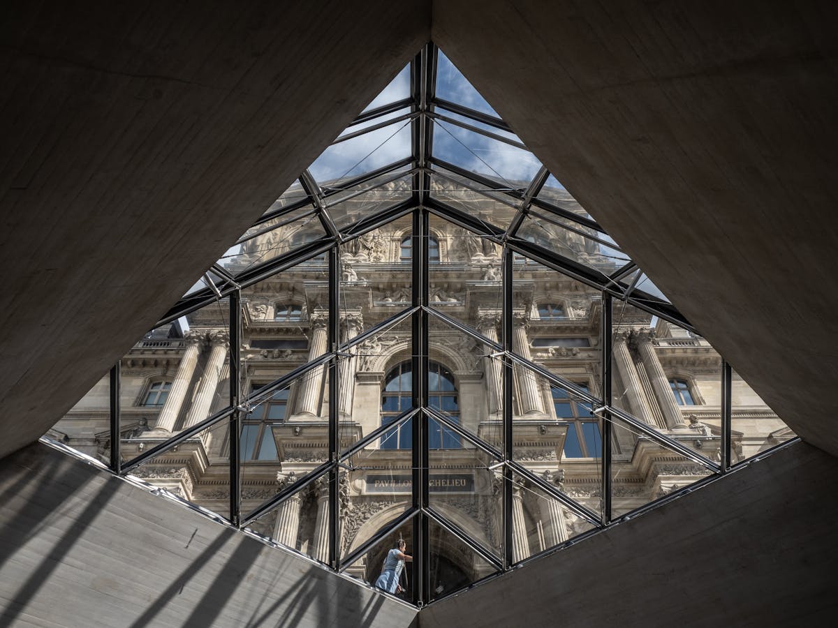 The Louvre Museum viewed through the iconic glass pyramid structure
