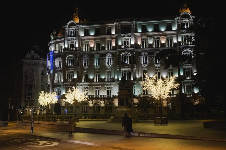 Ornate historic building facade in Madrid lit up at night