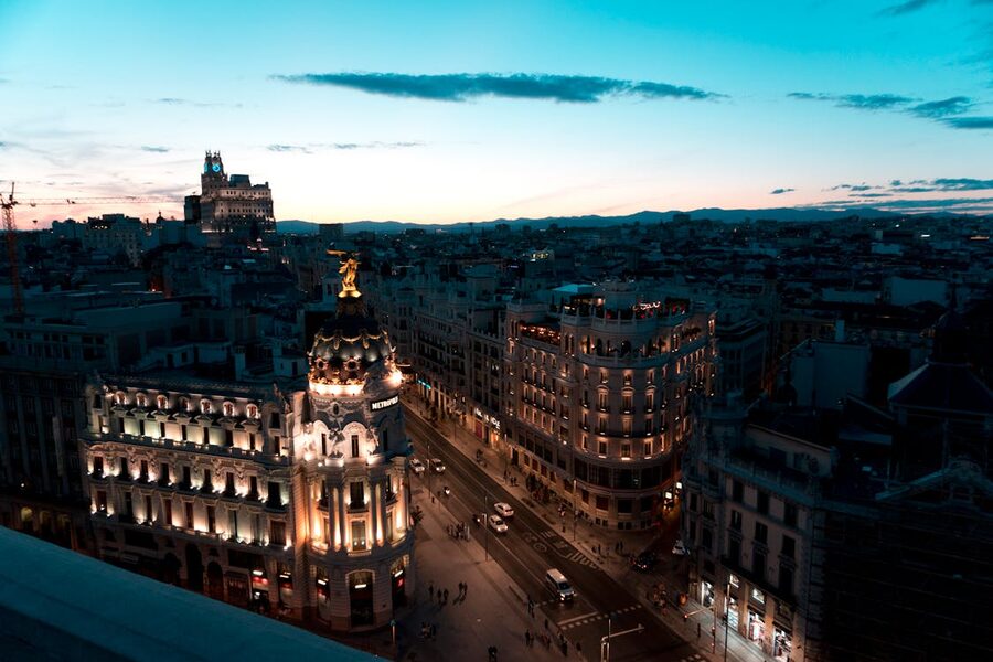 Madrid cityscape at twilight with illuminated buildings across the skyline