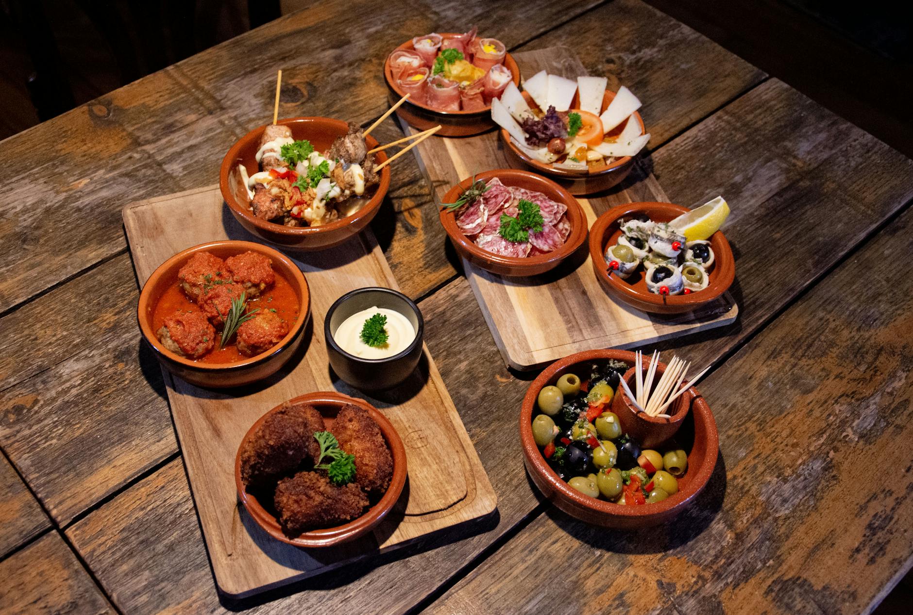 Traditional Spanish tapas served on rustic wooden boards