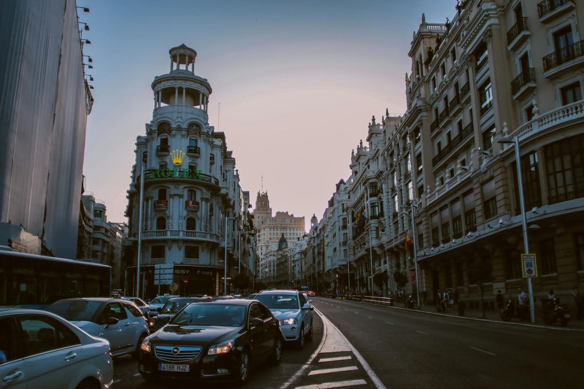 Evening traffic on Gran Via Madrid with historic buildings